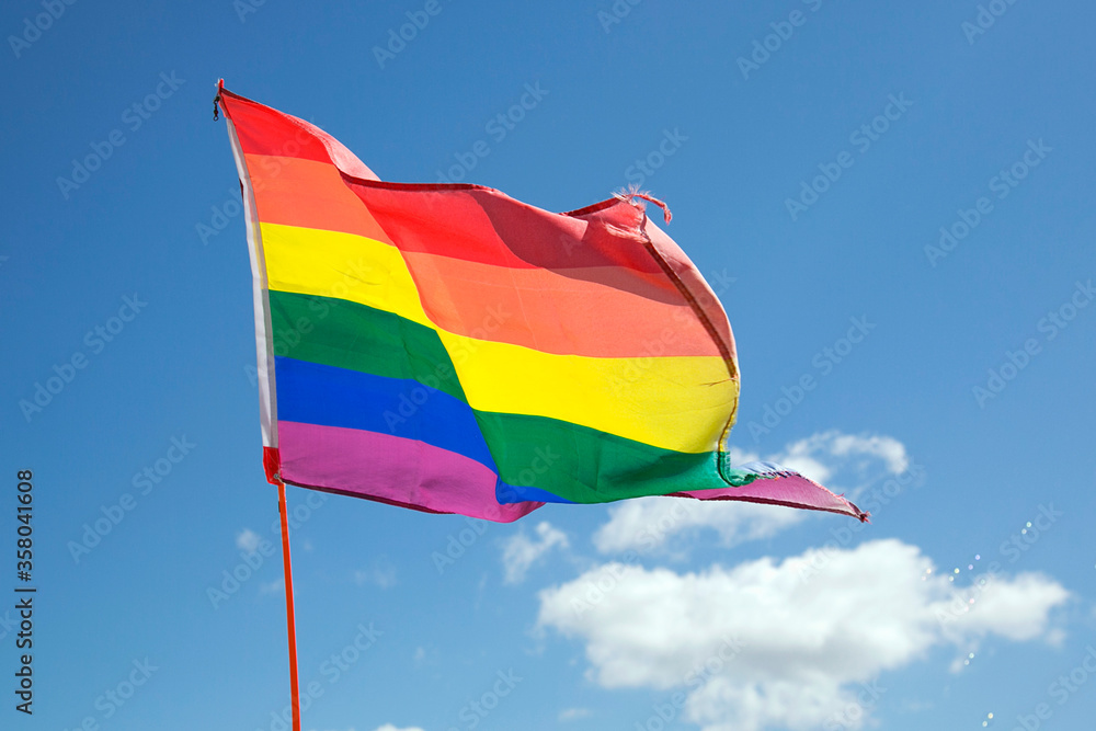 Rainbow Flag at a Gay Pride Parade with a blue sky background. Stock ...