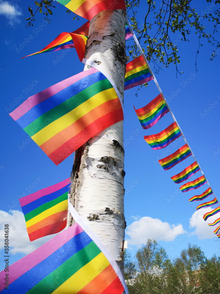 Rainbow Flags at a Gay Pride Parade hung from a tree with vibrant ...