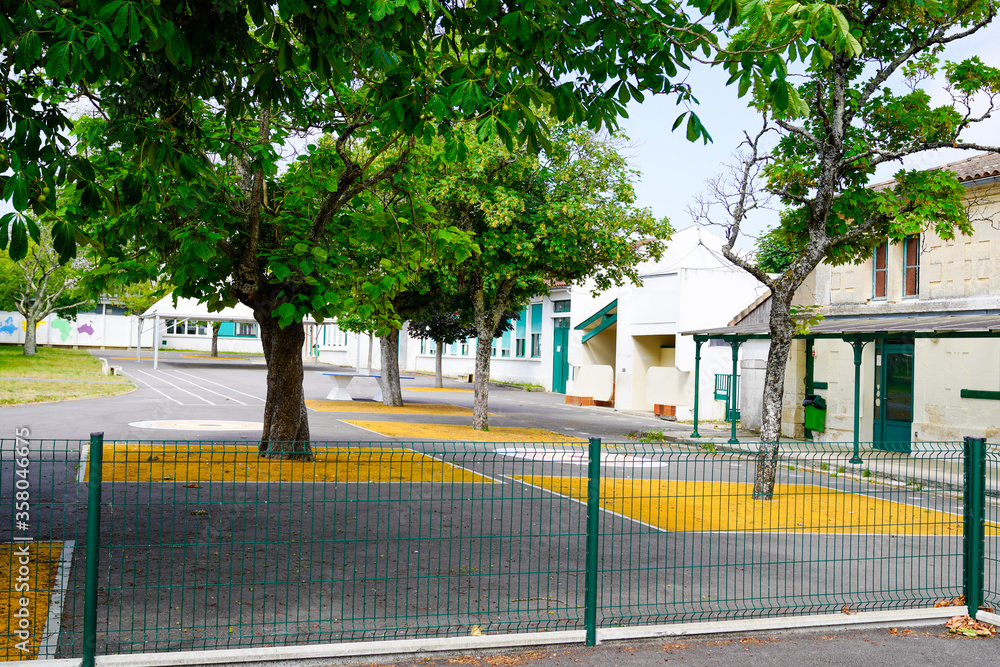 school children building exterior with kids playground on sunny day ...