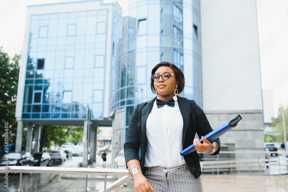 Pensive African American Female Lawyer In Stylish Formal Suit Holding