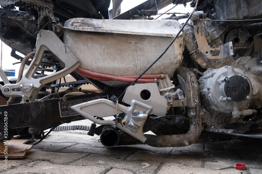 Vehicle, tricycle, after an accident. A burned motorcycle near the ...