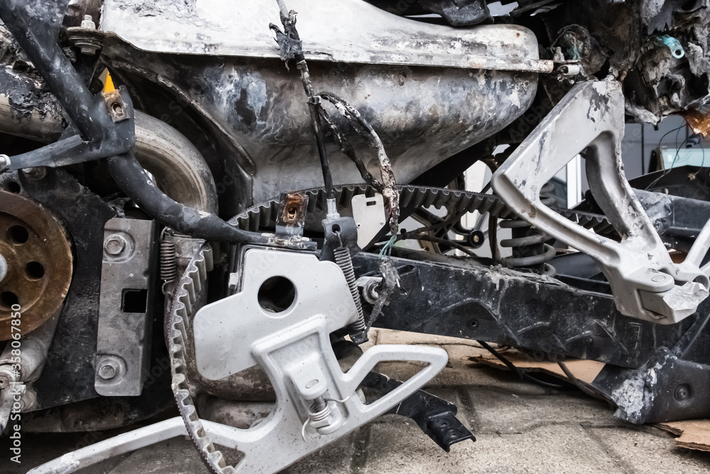 Vehicle, tricycle, after an accident. A burned motorcycle near the ...