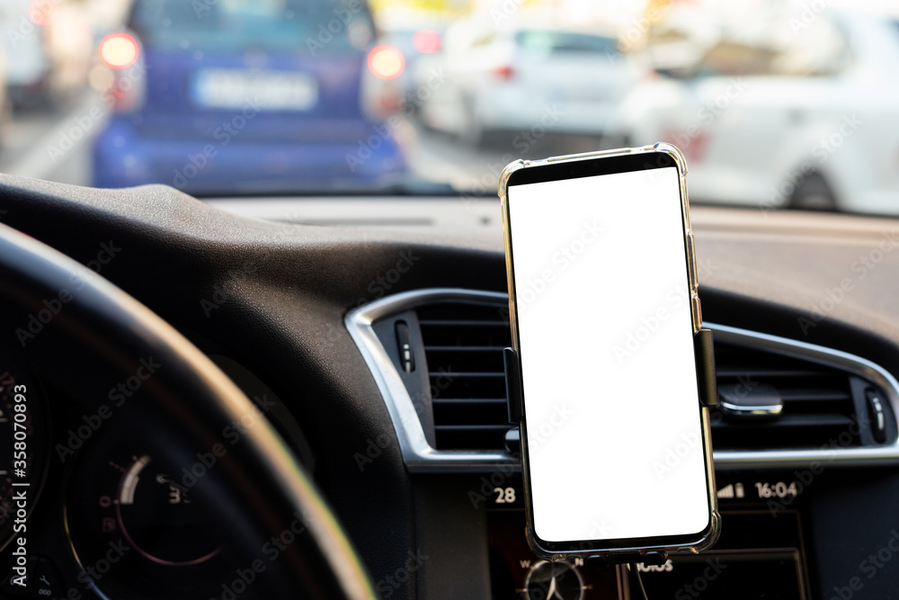 Modern smartphone device gadget mounted on phone holder at car ...