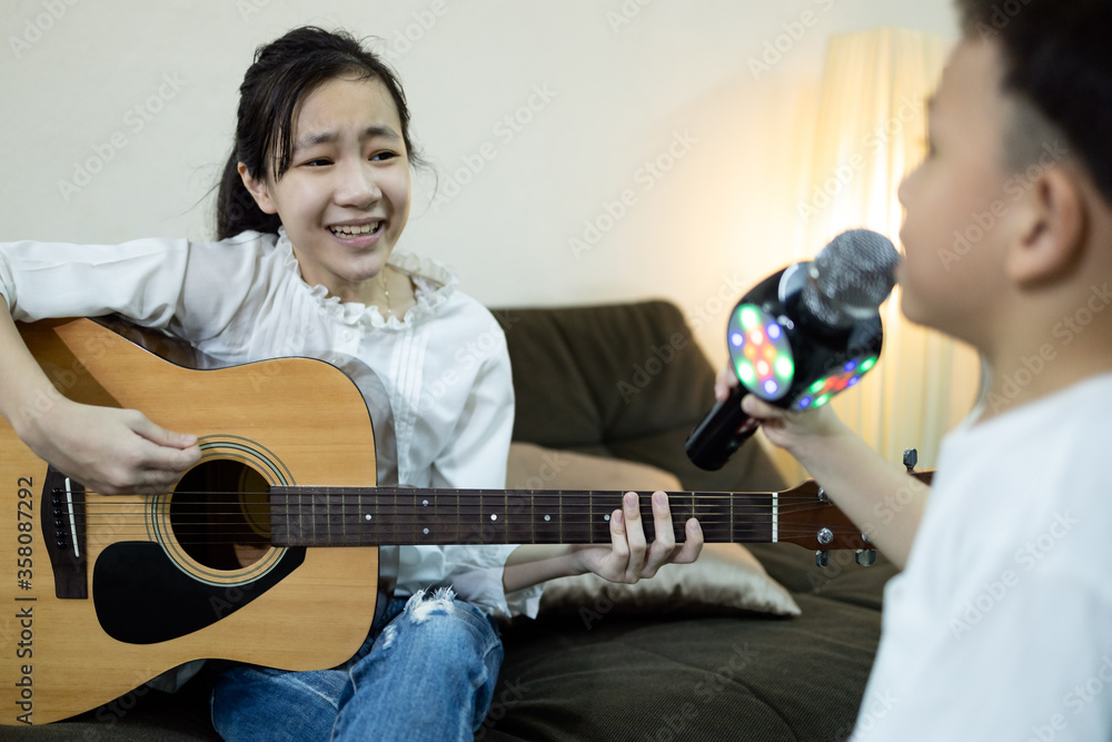 Happy asian child girl,kid boy singing a song together at home,family ...