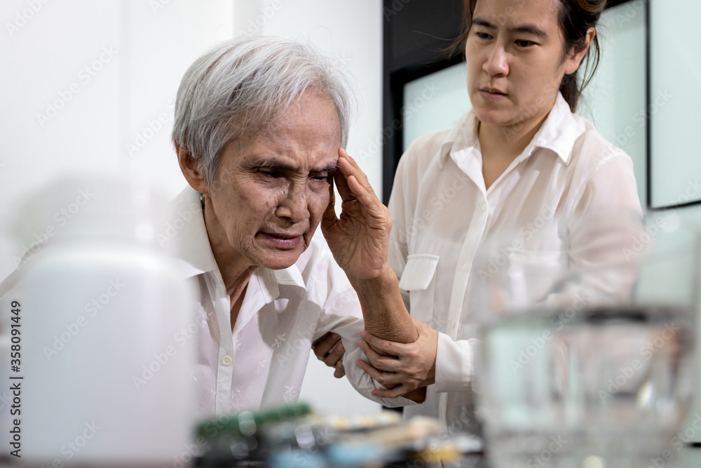 Foto de Asian elderly suffering from headache,painful cranial ...
