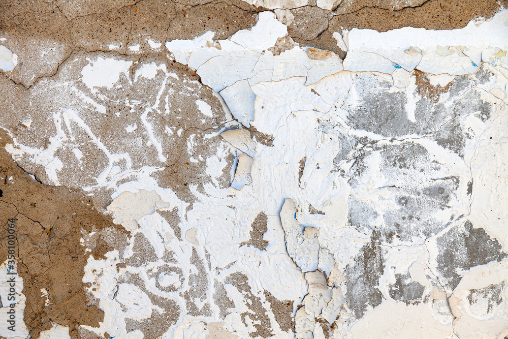 Cracked and crumbling plaster from a white wall - a wallpaper pattern ...