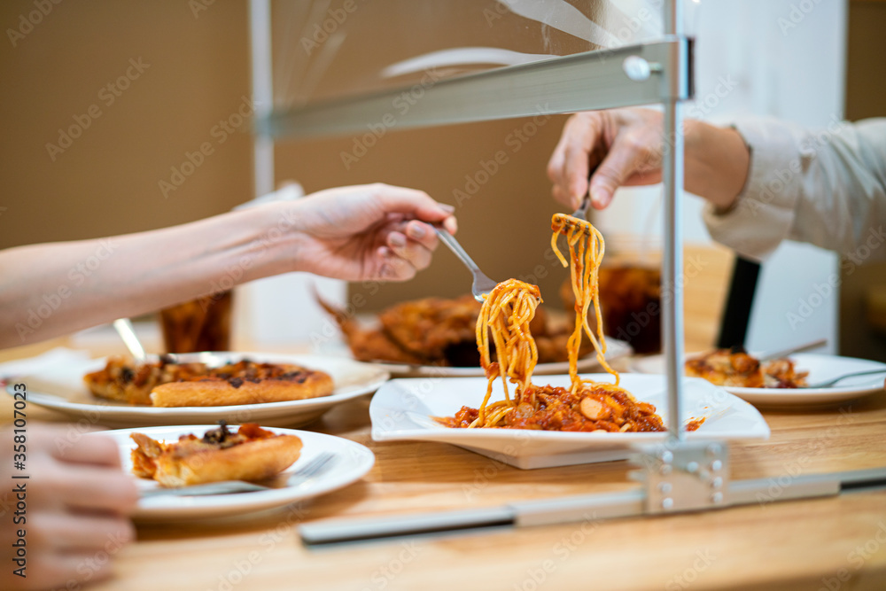 Asian woman eating food while siting separate and keep distance with ...
