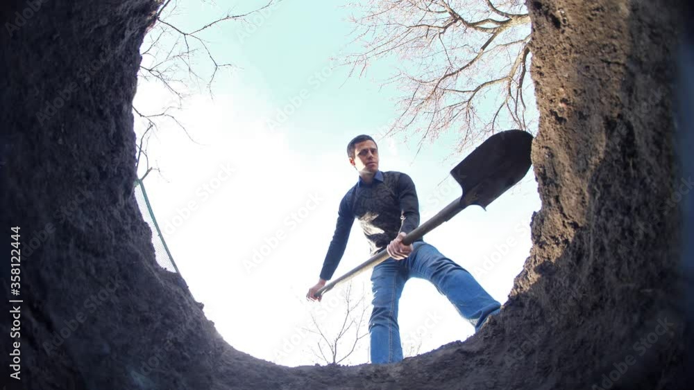 A man digs a hole in the ground Stock Video | Adobe Stock