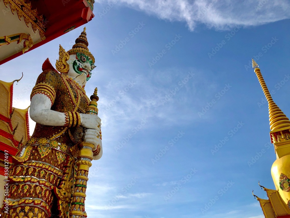 Giant guarding the Thai temple gate.Standing around the temple to ...