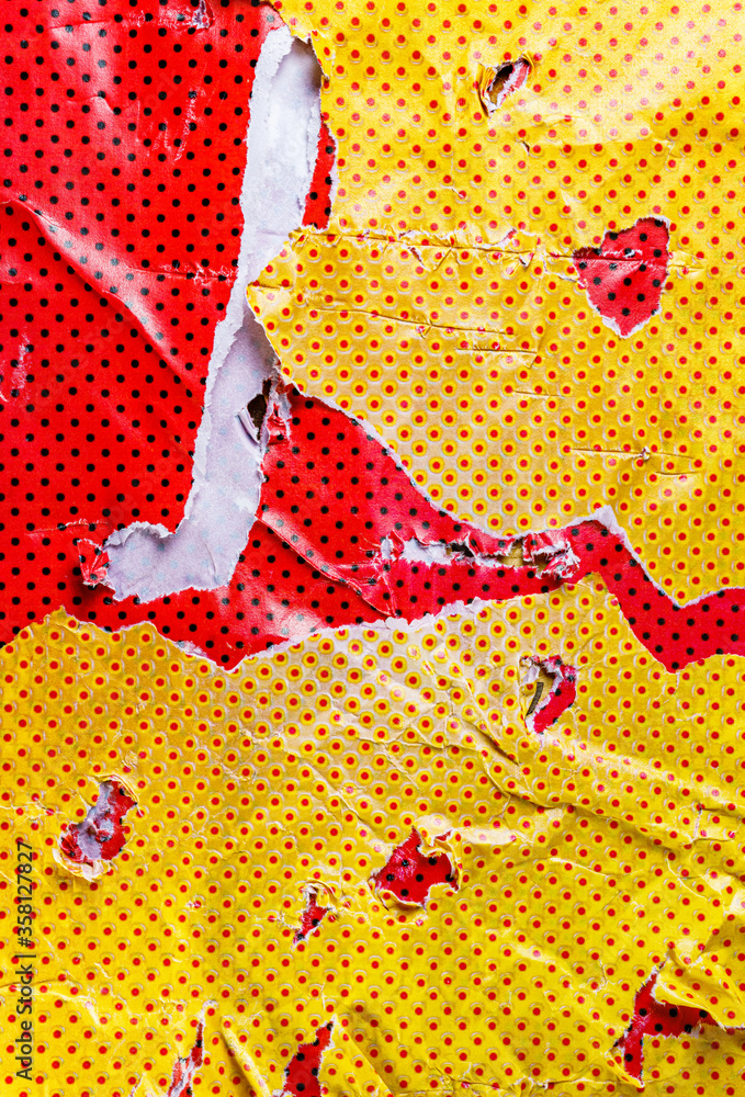 Wet destroyed layers of old street posters glued on top of each other ...