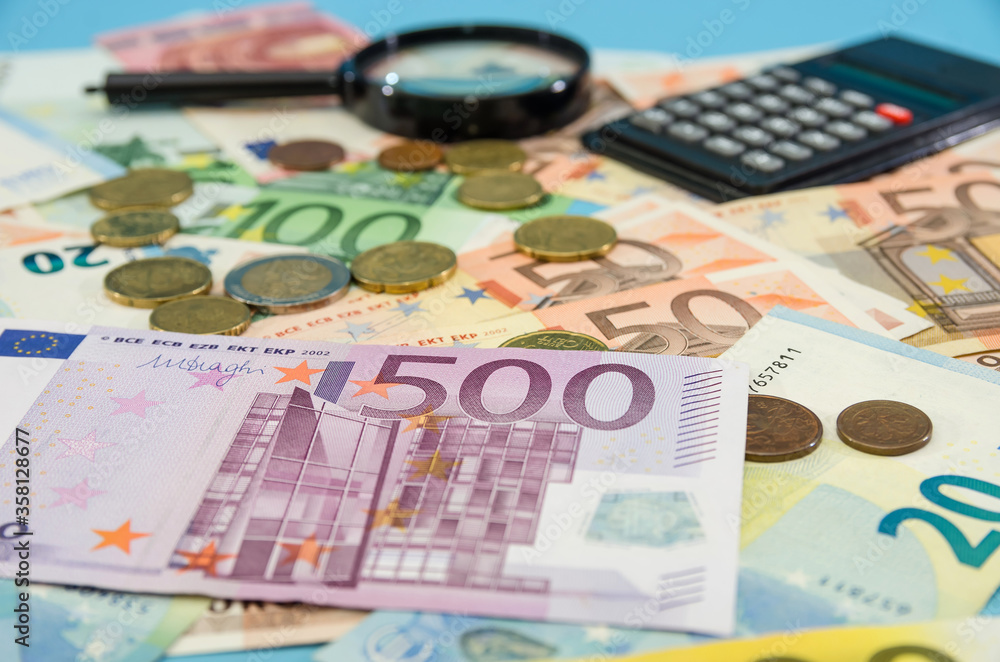 Euro banknote, calculator and magnifier. Much money. Savings concept ...