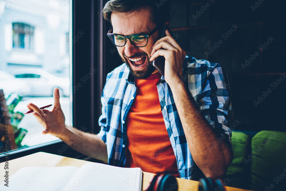Frustrated bearded young man in eyeglasses for vision correction ...