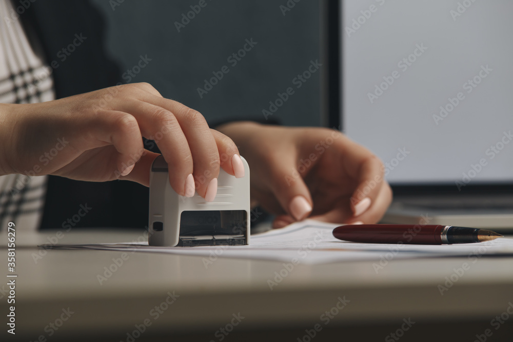 Female notary stamping agreement, company secretary, official document ...