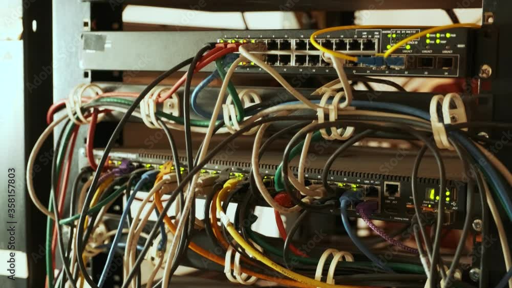 Network switch and ethernet cable in rack cabinet. Network connection ...