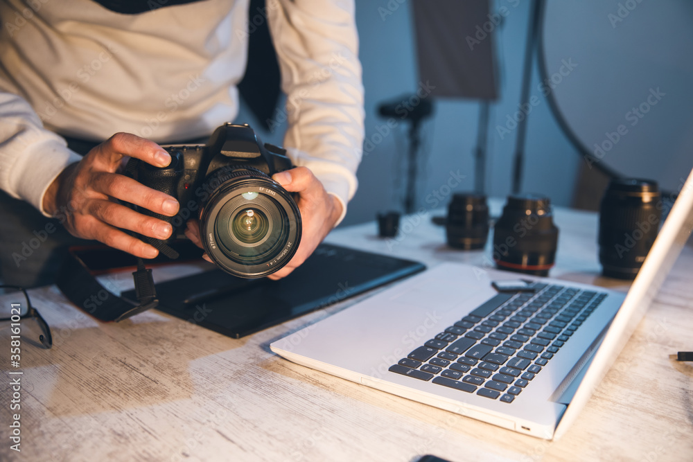 photographer hand camera with computer Stock Photo | Adobe Stock