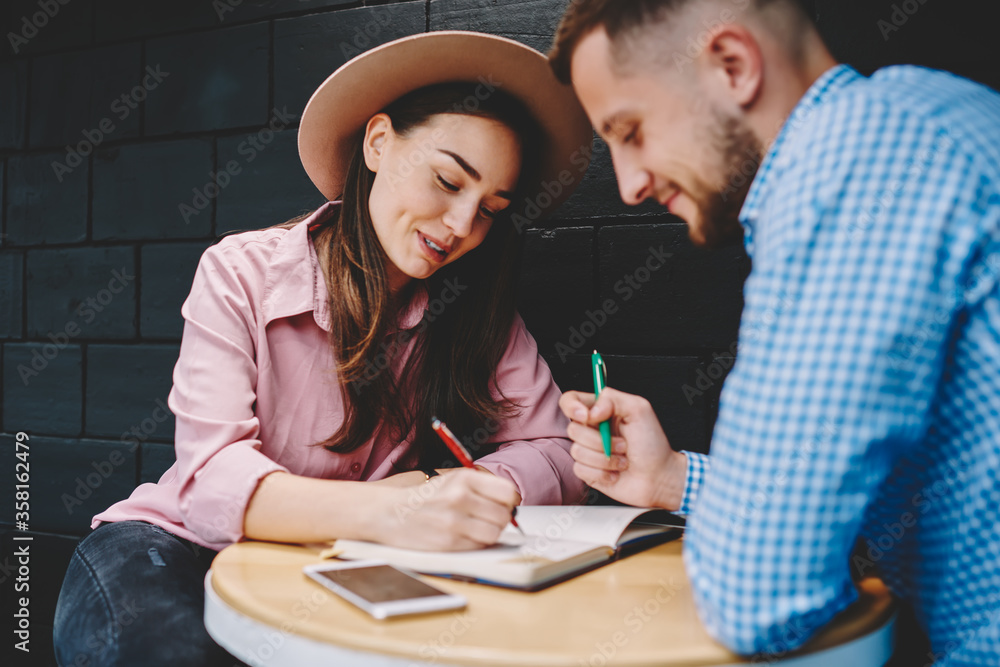 Couple in love dressed in casual wear discussing plan of common rest ...