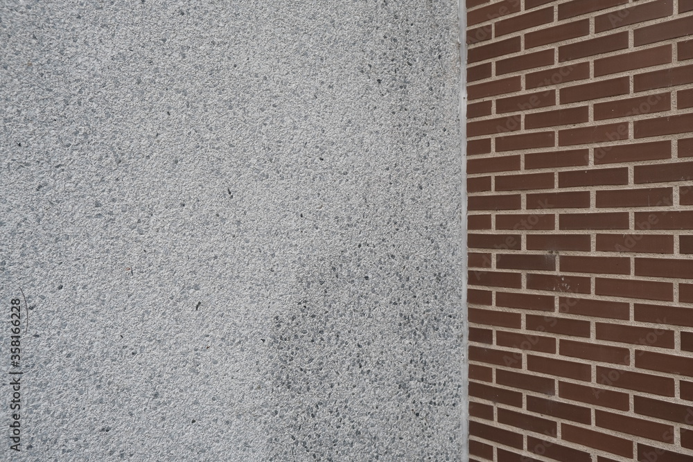 Intersection of brick wall with concrete wall Stock Photo | Adobe Stock