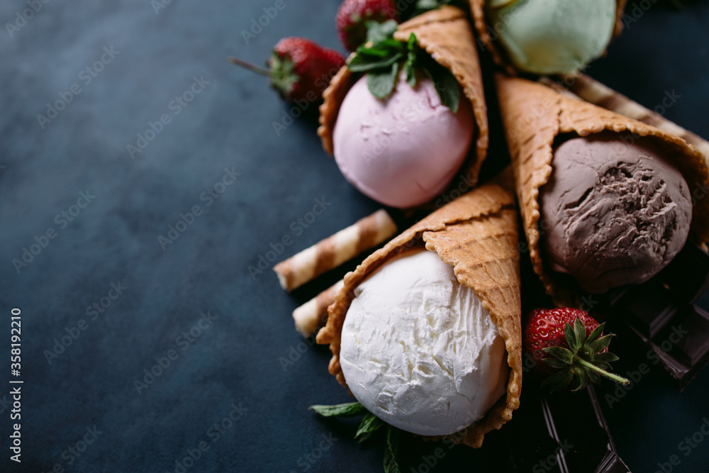 Ice cream background. Various flavored ice dessert scoops in waffle ...