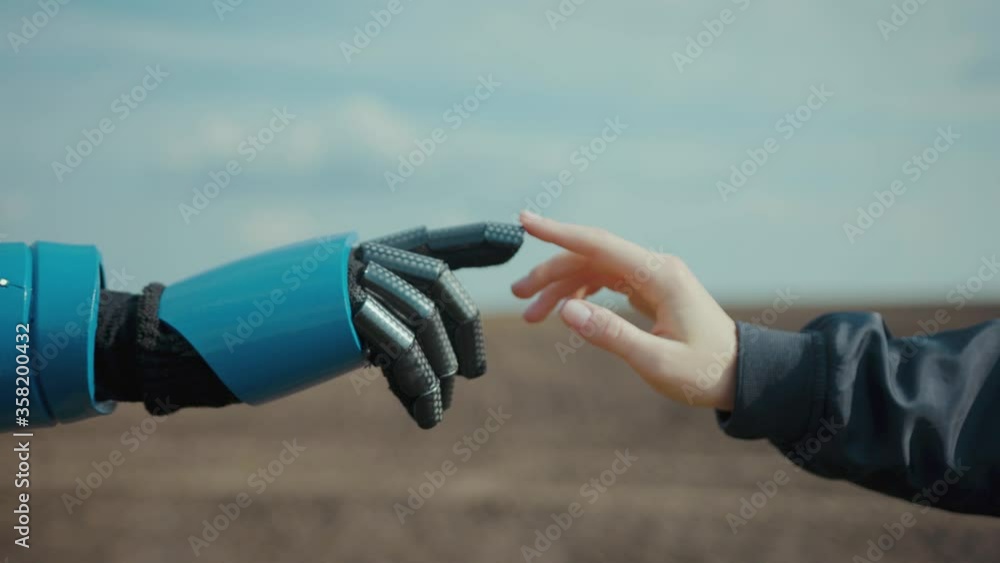 Woman pulling hand to robot repeating her motions outside. Close-up ...