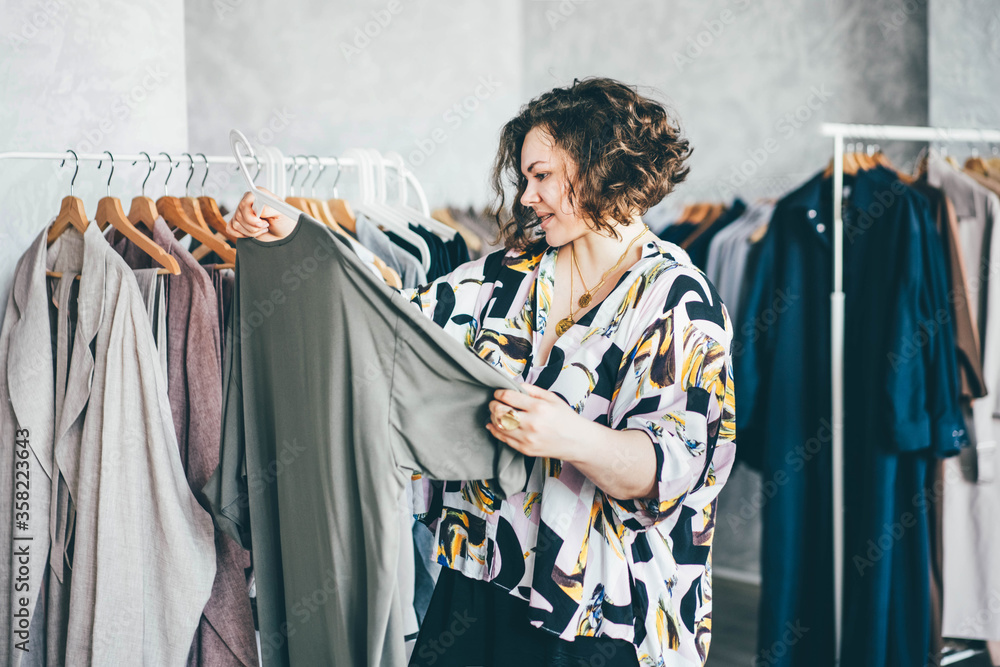 Plus Size Woman Choose Fashioned Dress in Store. Plus size women ...