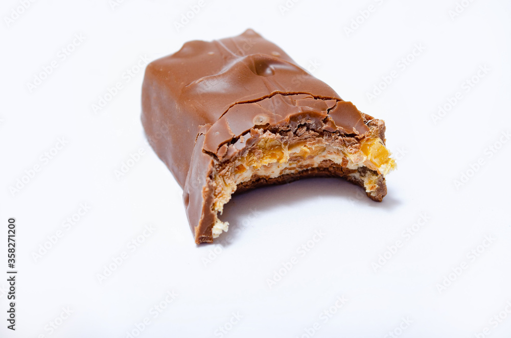 A piece of sneakerskie bitten on a white background teeth marks. One ...