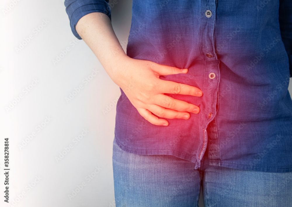 A woman suffers from pain in the appendix. Acute appendicitis, Crohn's ...