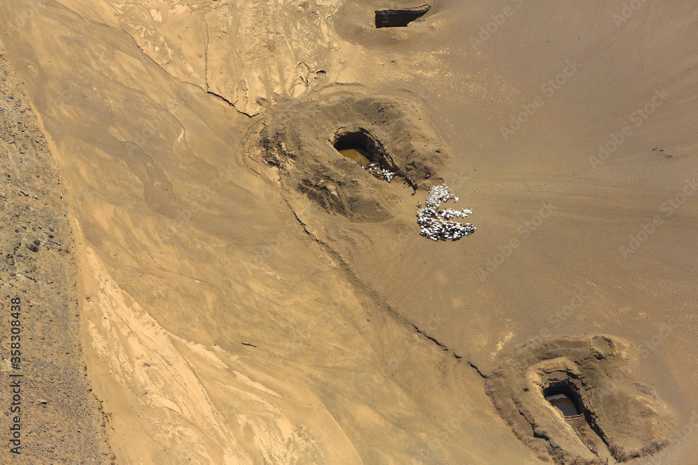 Aerial view of Masai herders taking their animals to water holes in the ...