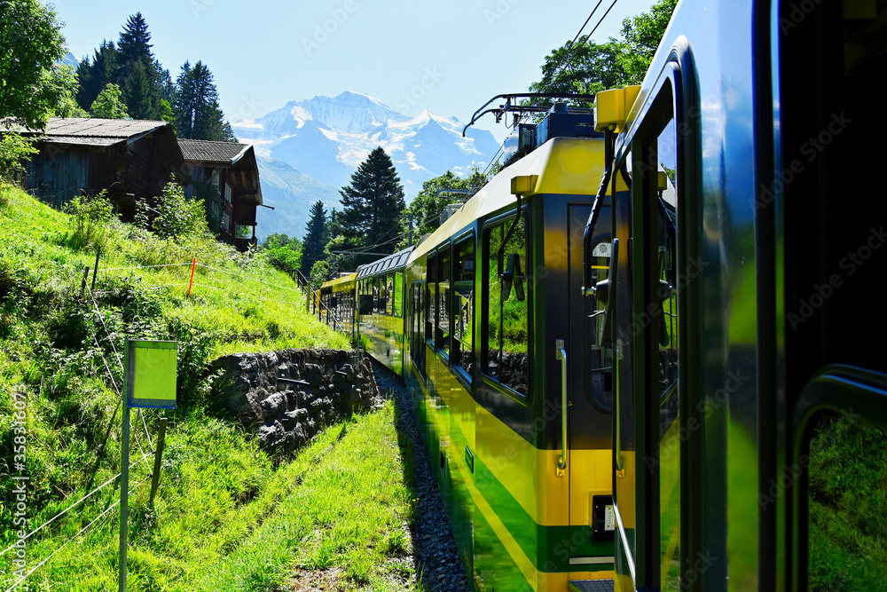 Beautiful scenery with yellow and green train - Bernese Highlands ...