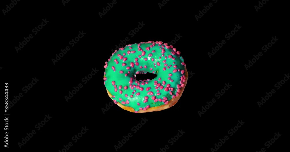 Rotating a green donut on a black isolated background for any purposes ...