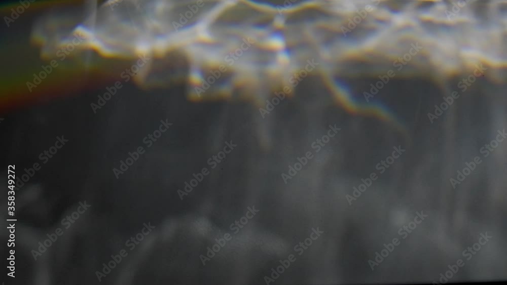 caustic water light effect with diffraction light rainbow on grey ...