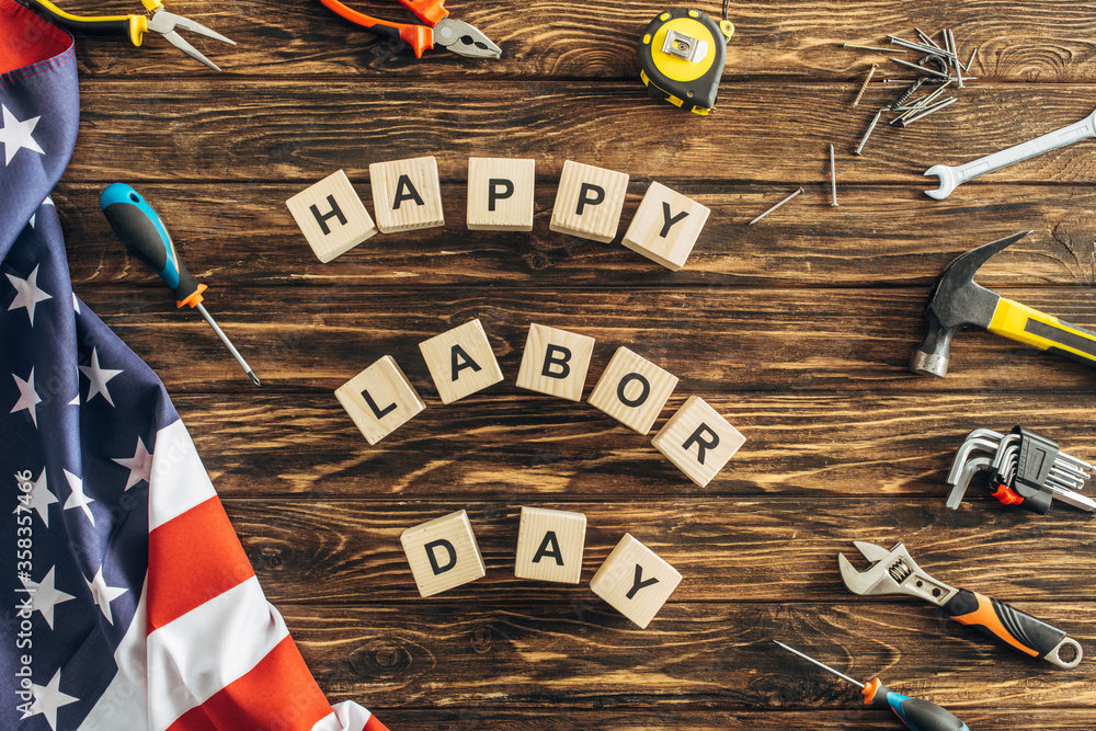 top view of tools and american flag near cubes with happy labor day ...