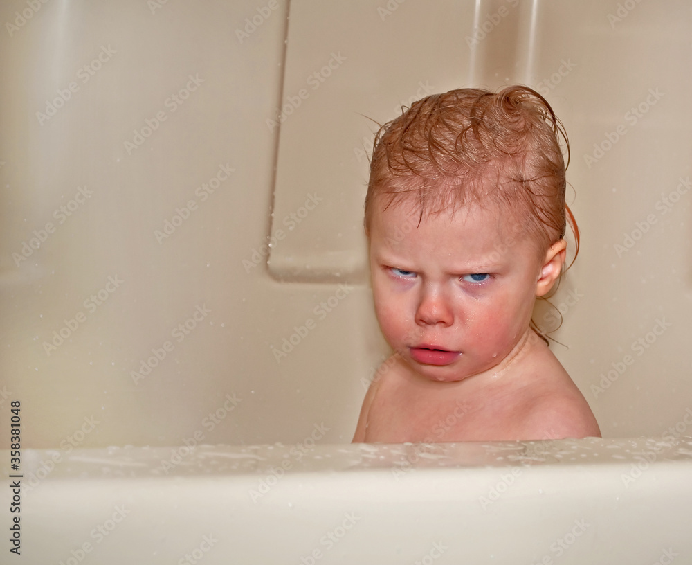 This toddler baby Caucasian girl with red hair is totally angry and mad ...