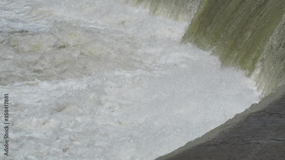 River water move down from a barrier to a lower level. Weirs are ...