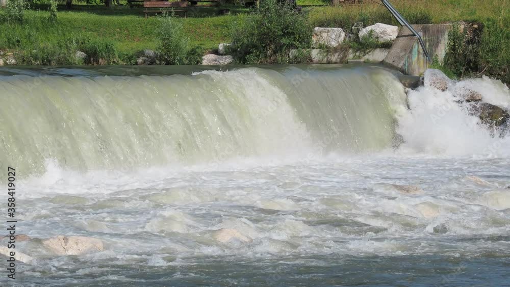 River water move down from a barrier to a lower level. Weirs are ...