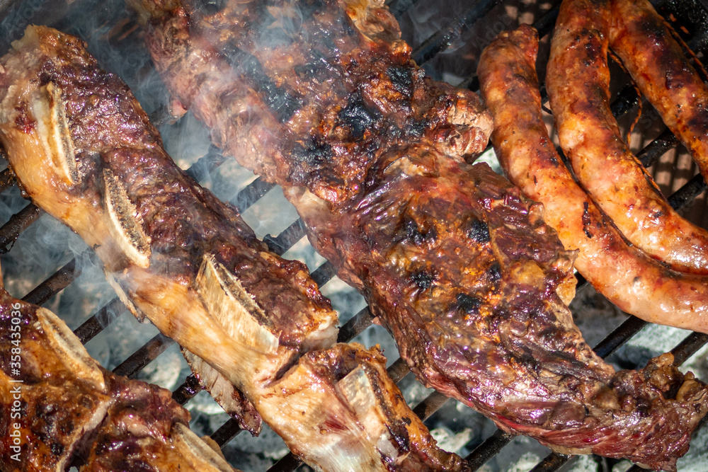 Parrilla con asado, vacío y chorizo Stock Photo | Adobe Stock