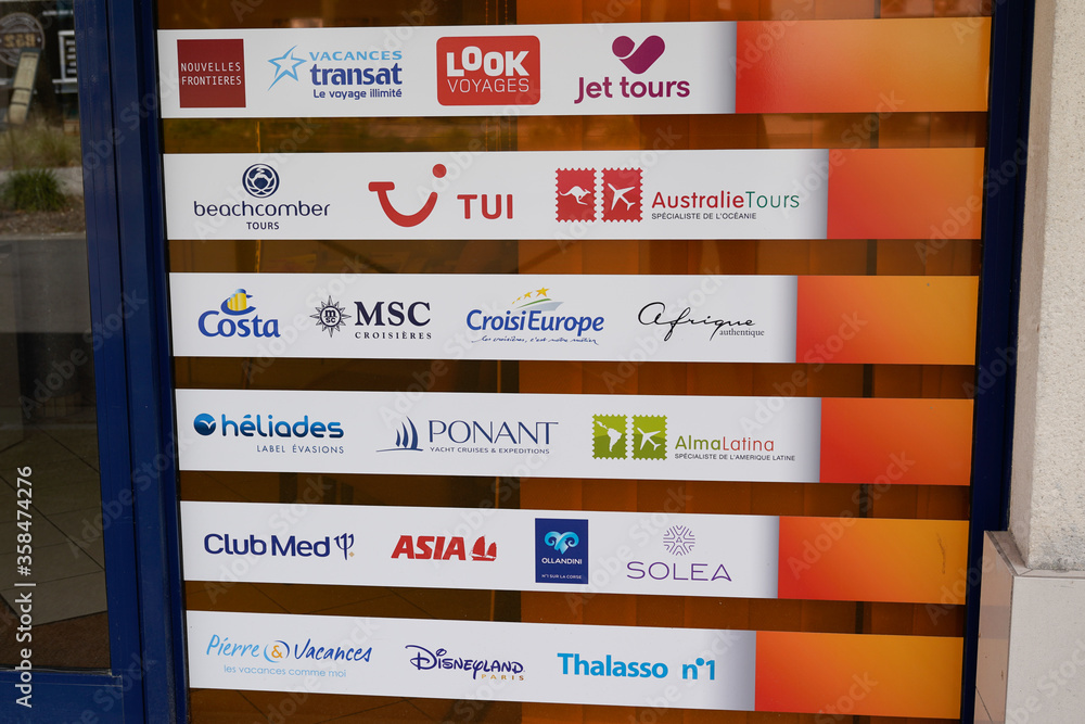 window of a travel agency gathering all sign logos of clubs tour ...