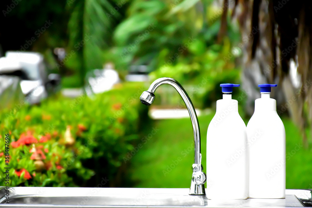 New normal, Hand soap bottles on stainless steel sink for hand washing ...