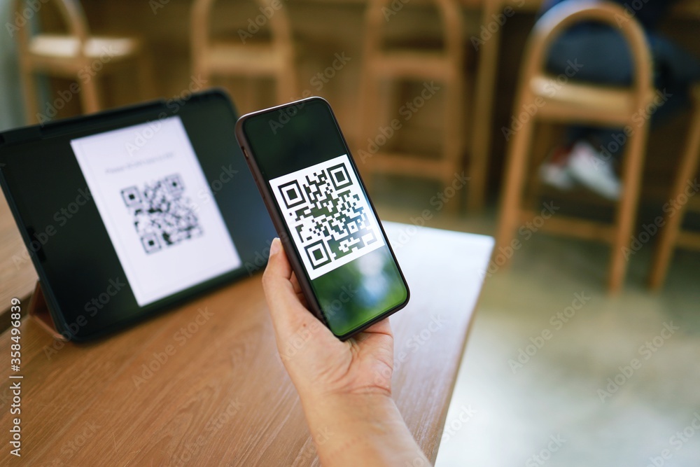Qr code payment. Woman scanning QR code online shopping cashless ...