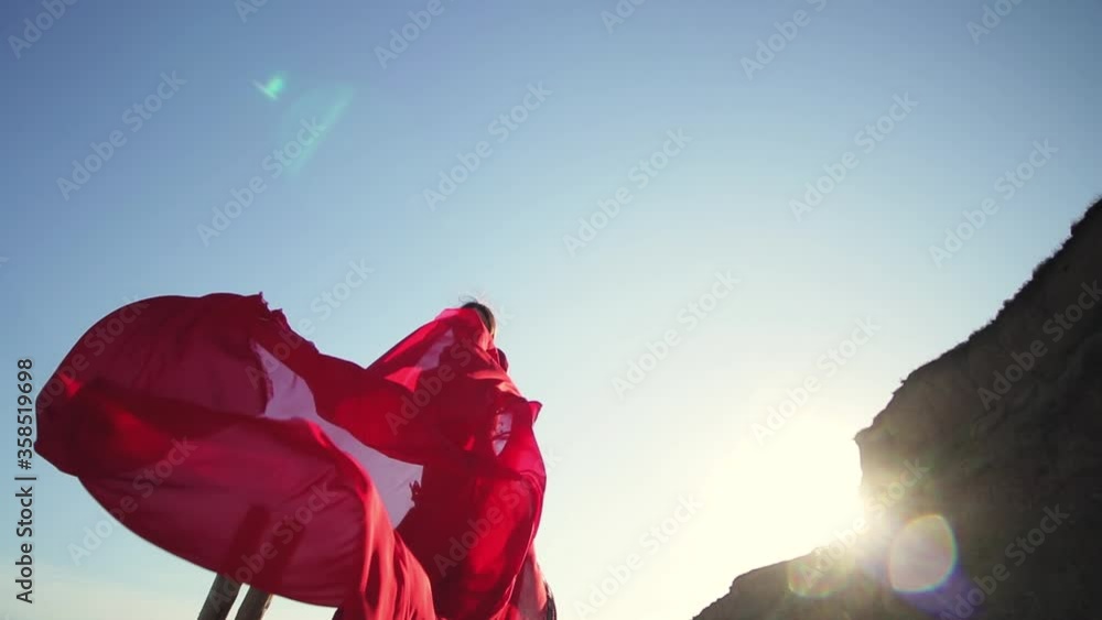 girl in a red dress with a burqa on her face and a red cloth in her ...