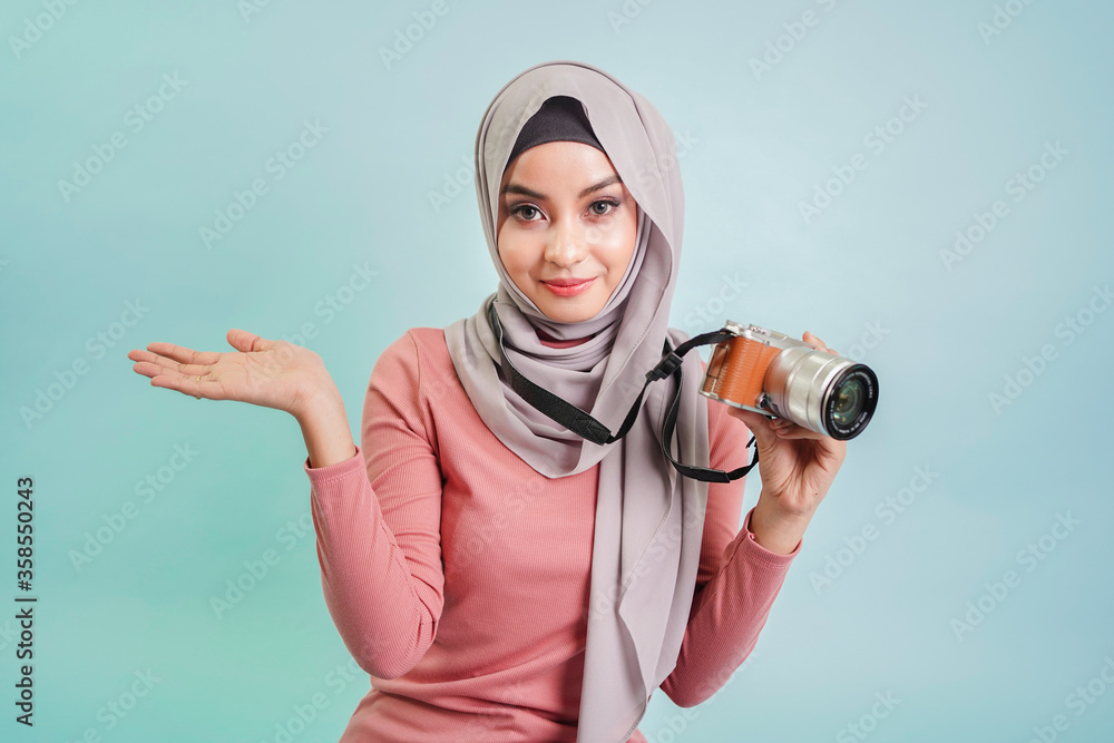 Muslim woman photographer with a digital camera. tourist holing camera ...