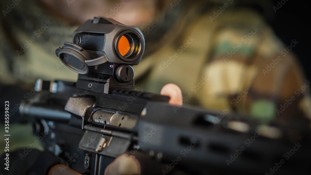 Abstract closeup of security contractor holding an AR15 Rifle with ...