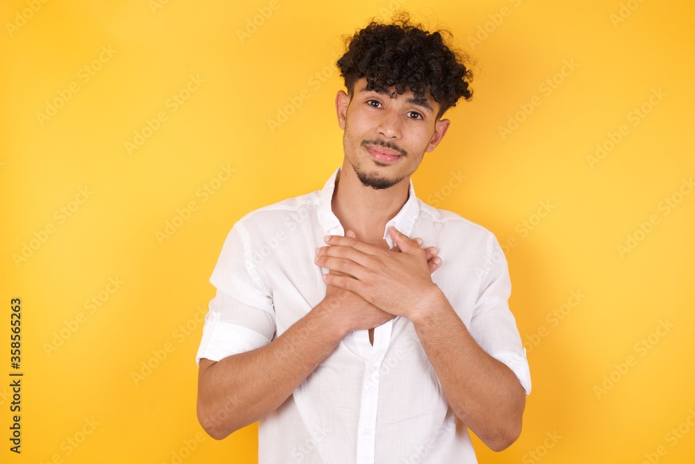 Faithful man closes eyes and keeps hands on chest near heart, shows his ...