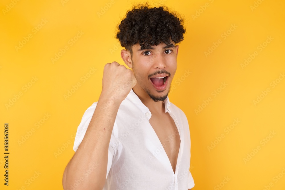 Overjoyed happy excited blond male glad to receive good news, gestures ...