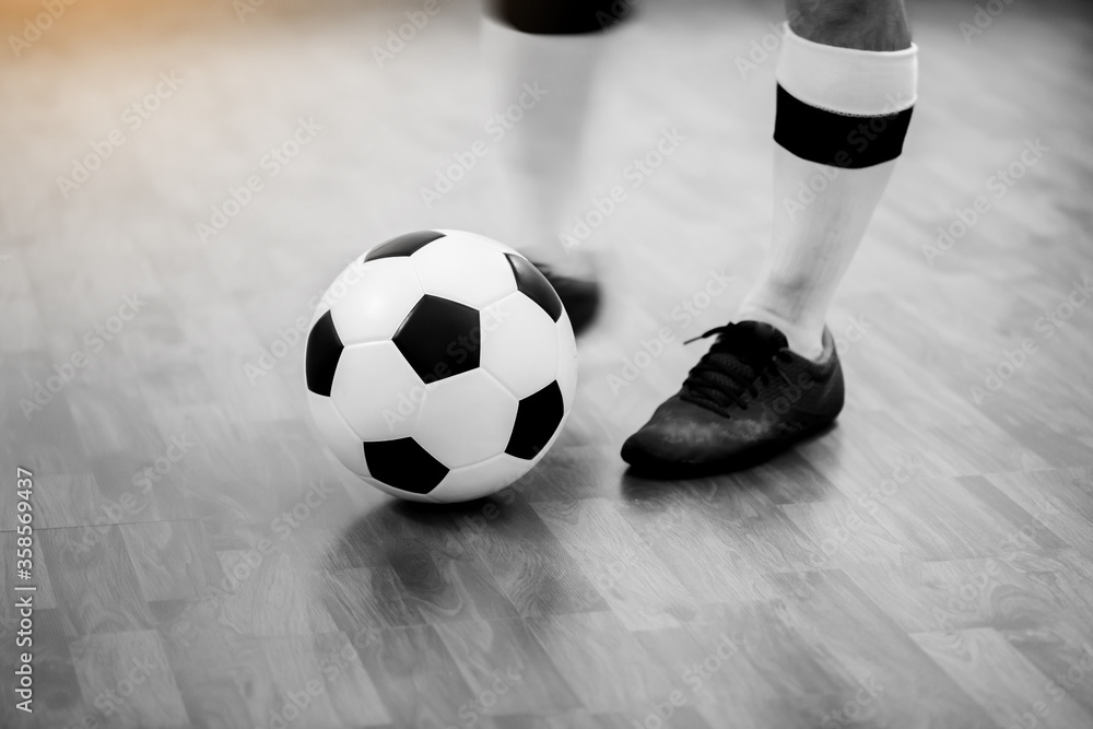 Black and white image of Futsal ball with motion blurry futsal player ...