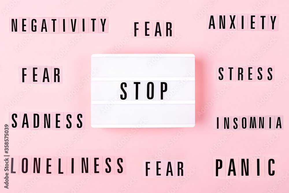 The lamp with letters STOP on pink background. Prevent negative ...