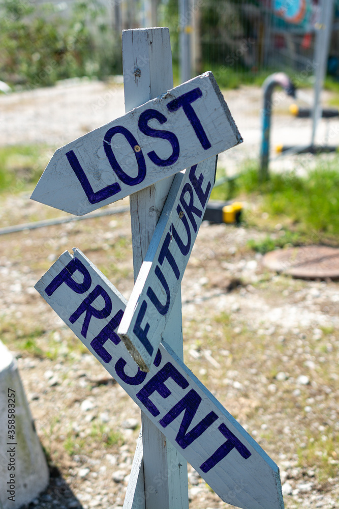 abstract sign showing lost, future and present headings. Located at a ...