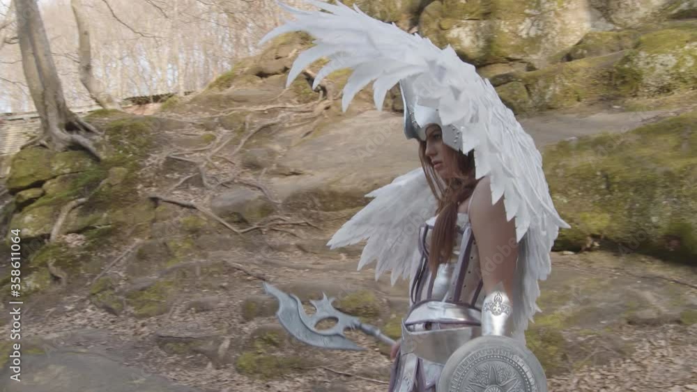 Young beautiful slim woman in image of warlike Valkyrie in silver ...