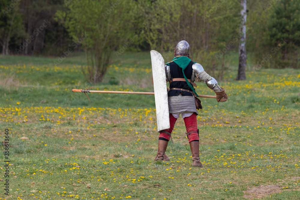 Knights in armor fight on the battlefield. Reconstruction of an ancient ...