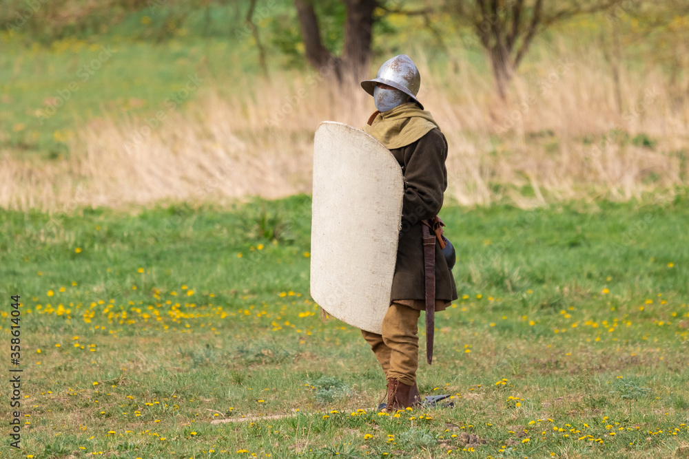 Knights in armor fight on the battlefield. Reconstruction of an ancient ...