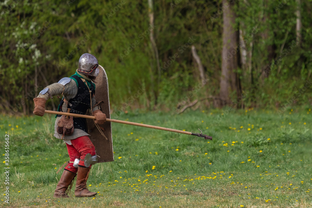 Knights in armor fight on the battlefield. Reconstruction of an ancient ...